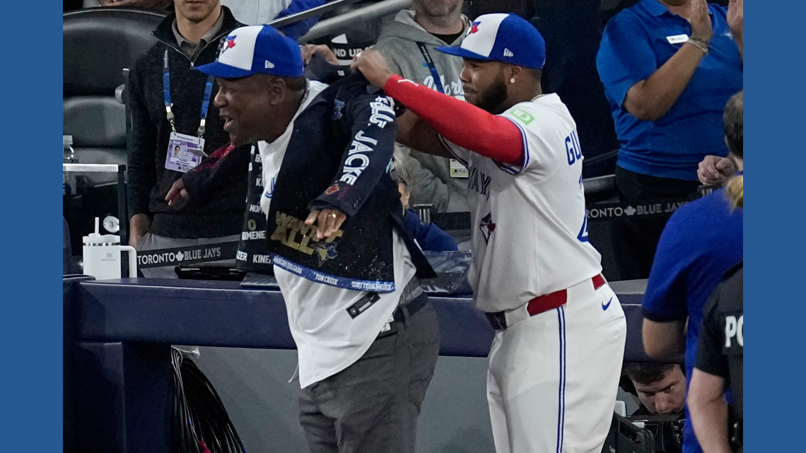 Joe Carter wears Blue Jays' home run jacket after throwing first pitch ...