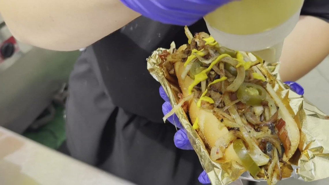 Vern Cooks gives hot dogs away to those in need on National Hot Dog Day ...